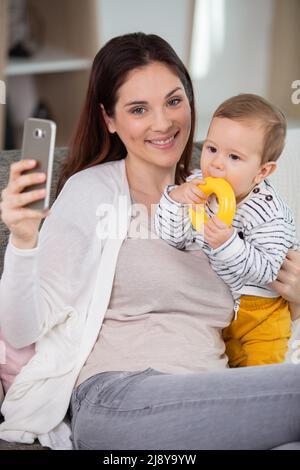 Portrait of mother with little daughter playing computer games Stock ...