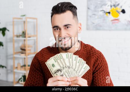 joyful bookmaker looking at camera and showing win gesture isolated on ...