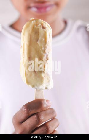 young men eating vanila flavor ice cream in a container Stock Photo - Alamy