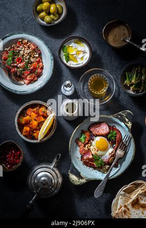 Fried eggs with greens, vegetables and cheese on a frying pan Stock ...