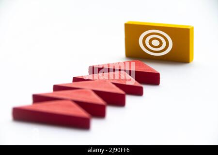 Triangles shape and target symbols on wooden blocks. Goal setting in ...