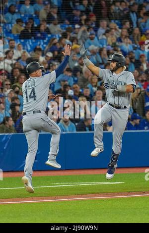 Seattle Mariners third base coach Manny Acta, left, celebrates the home ...