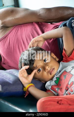 Indian boy sleeping with his father in train Stock Photo - Alamy