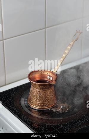 Runaway turkish coffeein a cezve on a stove Stock Photo - Alamy