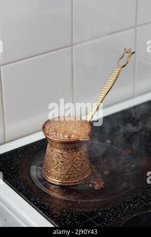 Runaway turkish coffeein a cezve on a stove Stock Photo - Alamy