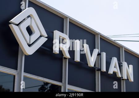 Rivian sign is seen at a Rivian service center, with an Amazon Prime ...