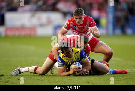 Jack Welsby of St. Helens is tackled by Tariq Sims of Catalan Dragons ...