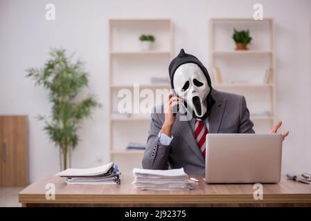 Devil businessman employee working in the office Stock Photo - Alamy