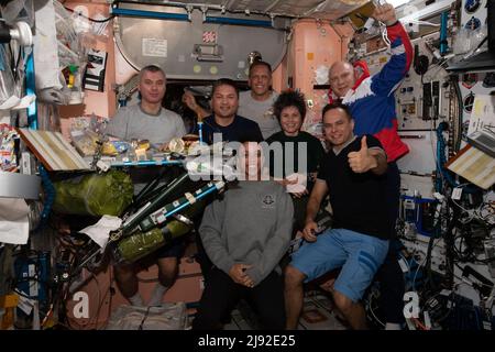 The Expedition 67 crew pose together for a portrait during dinner time ...