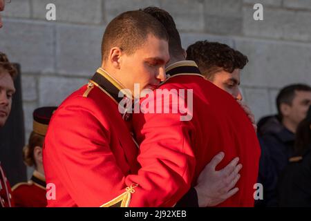 Classmates of the four fallen officer cadet embrace during a ...