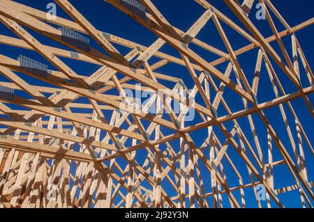 Structural supports of a house under construction showing steel truss ...