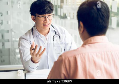 Asian doctor is examining the abnormal items of the body and diagnosing ...