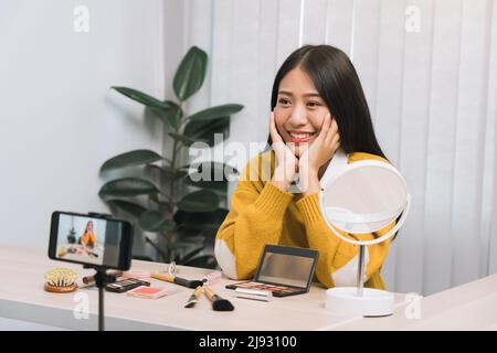 Asian teenage girls doing makeup vlogs and using a video mobile camera ...