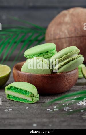 Lime dessert cake macaron or macaroon on trendy pastel lilac background ...