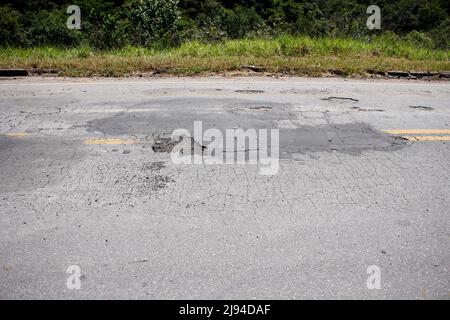 highway roof with defective and spoiled asphalt, dangerous for traffic ...
