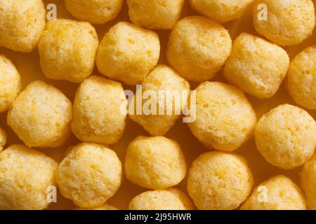 top view of puffed and salty cheese pops on yellow Stock Photo - Alamy