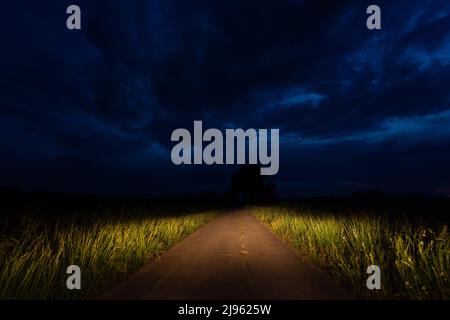 Ebing, Germany. 20th May, 2022. Dark clouds pass over a ticket machine ...
