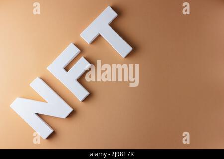 Non fungible token. NFT inscription of multicolored letters on a purple ...