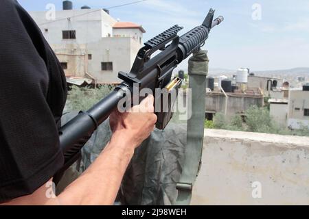A gunman from the Islamic Jihad movement participates in the funeral of ...