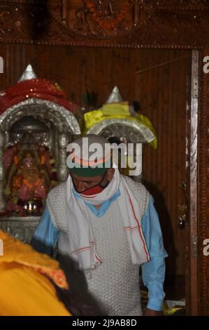 A Pujari or Hindu priest wearing traditional outfit makes the Mudra ...