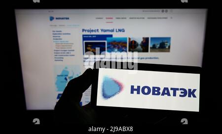 Person holding monbile phone with logo of Japanese company Tokyo Steel ...