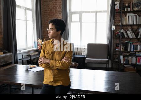 Thoughtful African woman staring aside at copy space, studio shot Stock ...