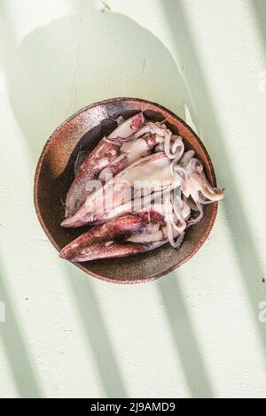 Fresh squid calmari on white background Stock Photo - Alamy