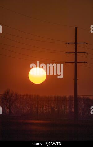 Harnassing the power of sun. Telephoto of a setting sun, contrasted ...