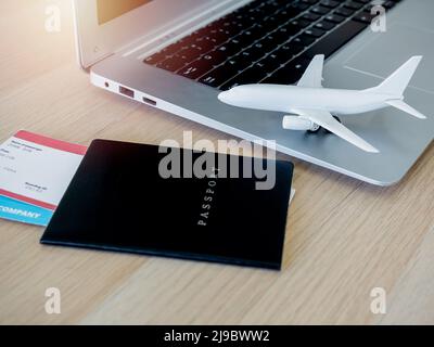 Passport black cover with flight ticket near white airplane toy on ...