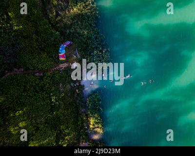 overhead view of leak beach blue water. people having fun swimming ...