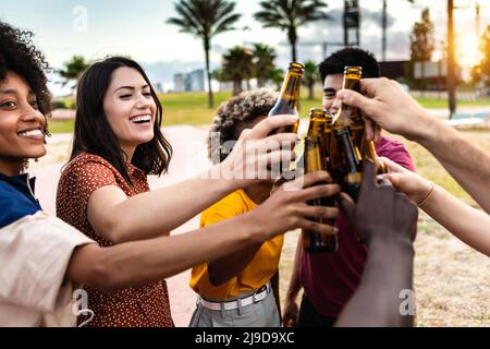 Group of teenagers having fun drinking and having brunch outdoors ...