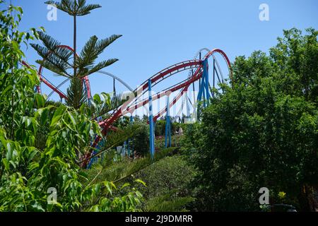 Inverted roller coaster with narrow metal rails, an ideal summer day to ...