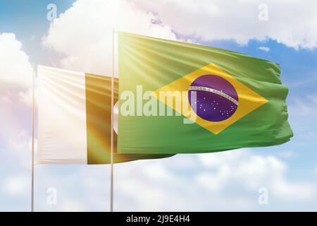 Brazil and Pakistan flags waving together on blue cloudy sky, two ...