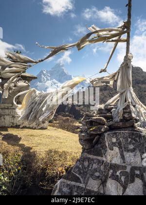 Ama Dablam (6856m) and prayer flags at a small pass above Khunde ...