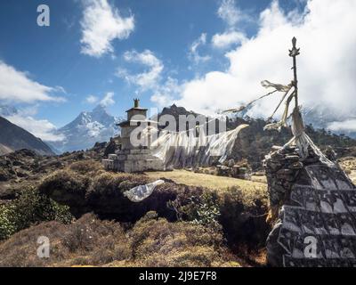 Ama Dablam (6856m) and prayer flags at a small pass above Khunde ...