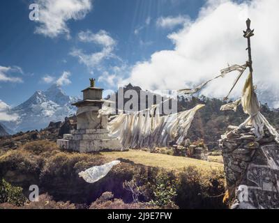 Ama Dablam (6856m) and prayer flags at a small pass above Khunde ...