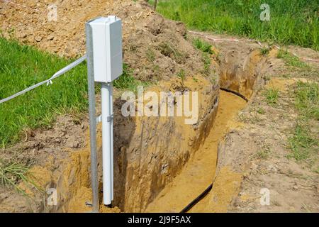 Underground electricity cable junction box being installed Stock Photo ...