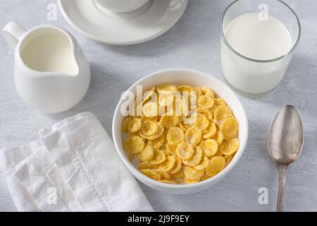 Sweet crunchy cornflakes on a gray textured background. Fast tasty ...
