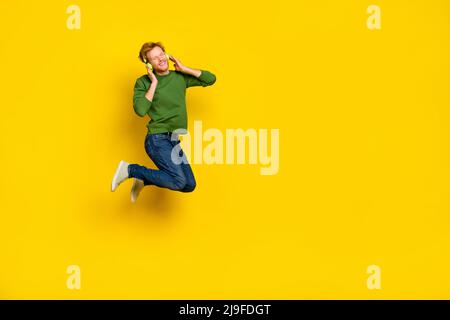 Photo of funny dreamy guy dressed white sweater comparing arms ...