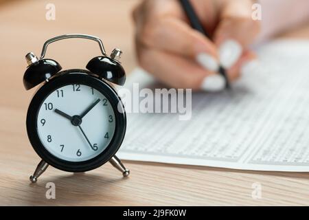 Writing, assessment and quiz with girl in classroom for test, child ...