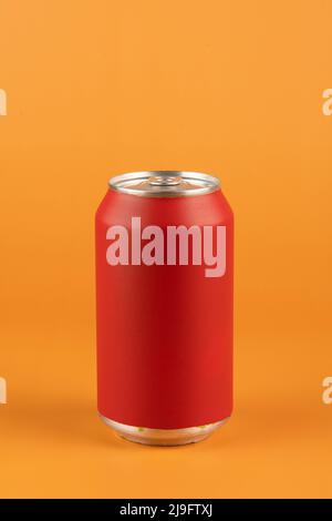 red aluminum can isolated on orange background Stock Photo - Alamy