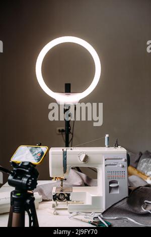 Shooting video of the sewing process, workshop on clothing design on ...