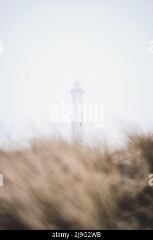White lighthouse in mist Stock Photo - Alamy