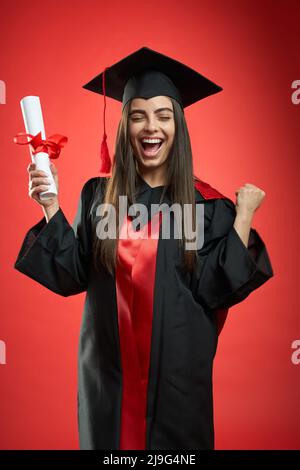 Front view of glad girl with bachelor, master degree holding diploma ...