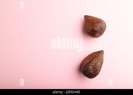 Salak or snake fruit on pink pastel background. Side view, copy space ...