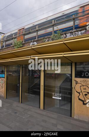 Small business redeveloped under railway arches by train and overground ...