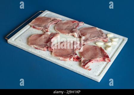 Raw pork steak over board for cooking Stock Photo - Alamy