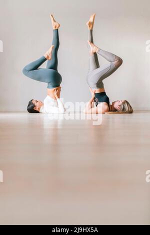 People stand in front of a wall decorated with book titles in Kolkata ...