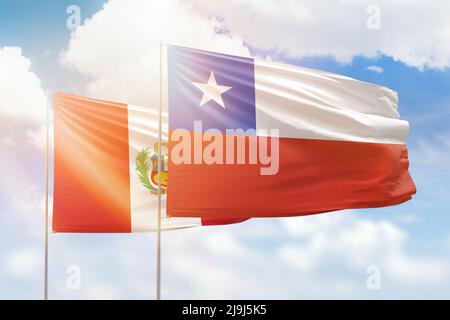 Chile and Peru flags waving together on blue cloudy sky, two country ...