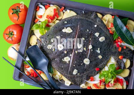 Cooked Whole Turbot fish in baking pan oven with potatoes, bell pepper ...